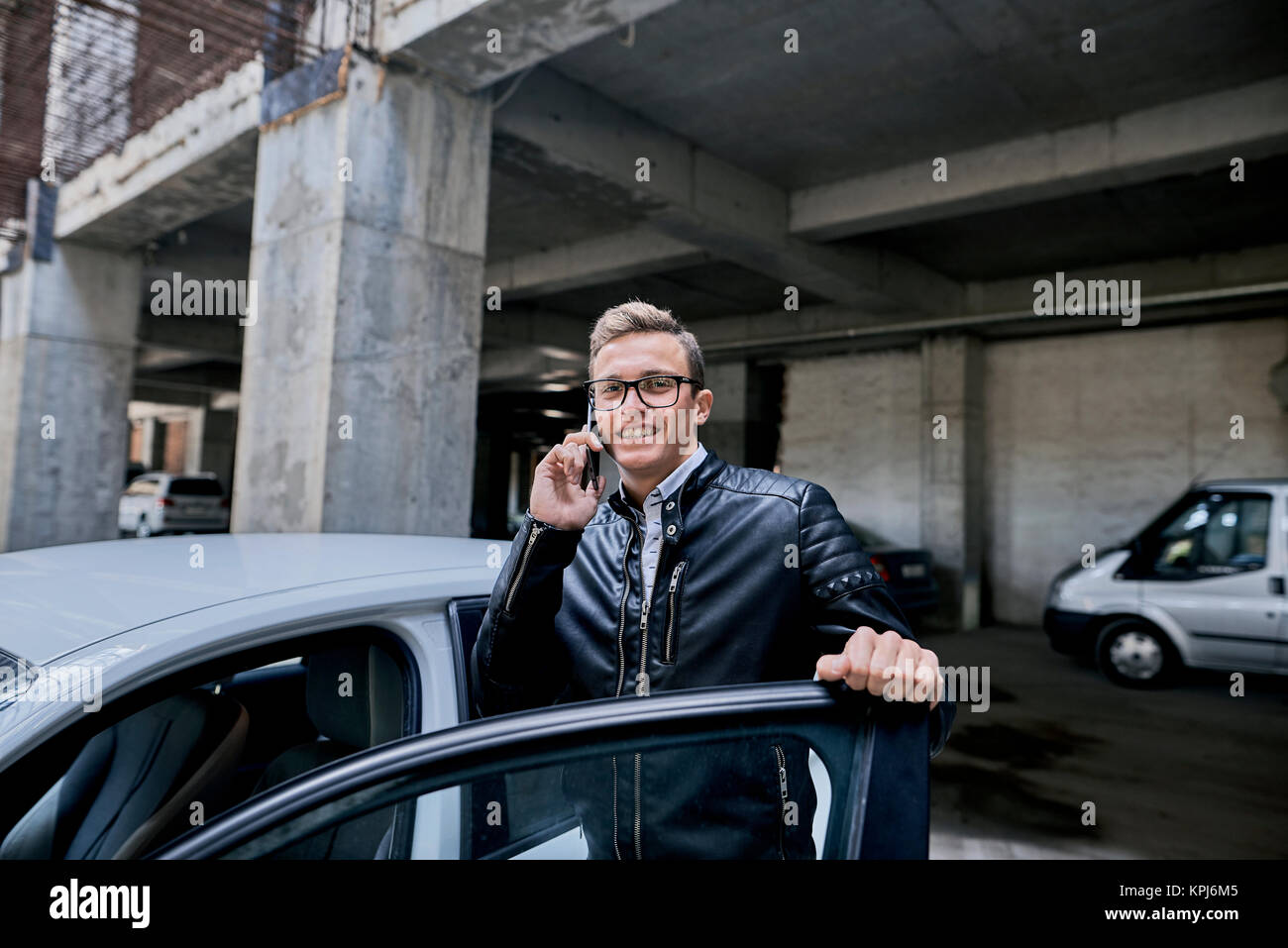man gets out of the car Stock Photo - Alamy