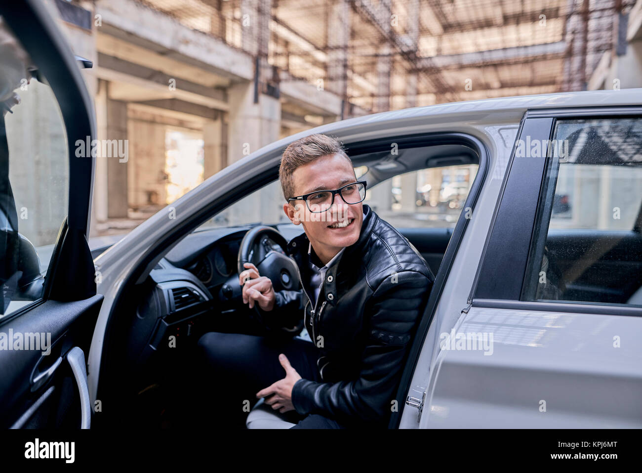 man gets out of the car Stock Photo - Alamy