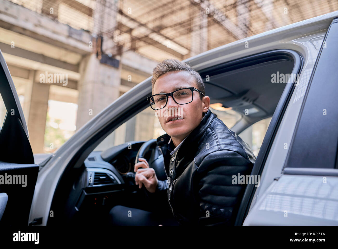 man gets out of the car Stock Photo - Alamy