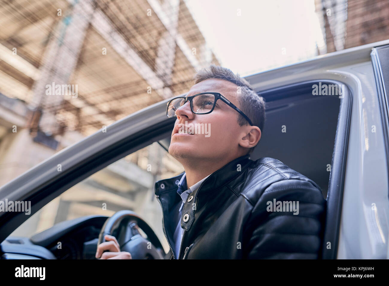 man gets out of the car Stock Photo - Alamy