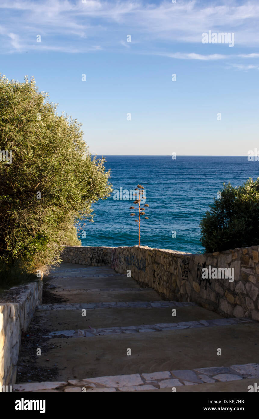 Paved path to blue clear mediteranean sea at beach in sunny day Stock ...