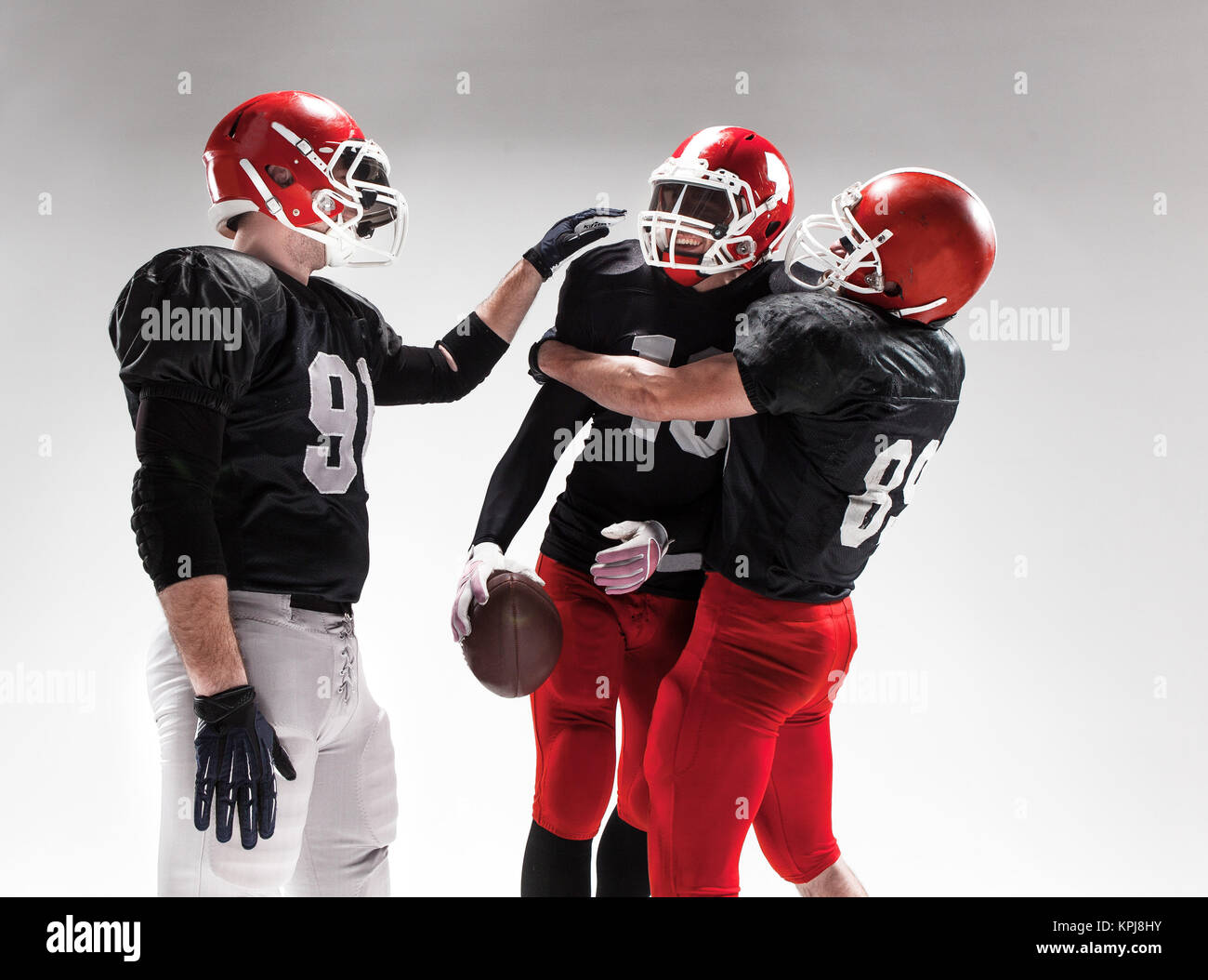 The three american football players posing on white background Stock ...