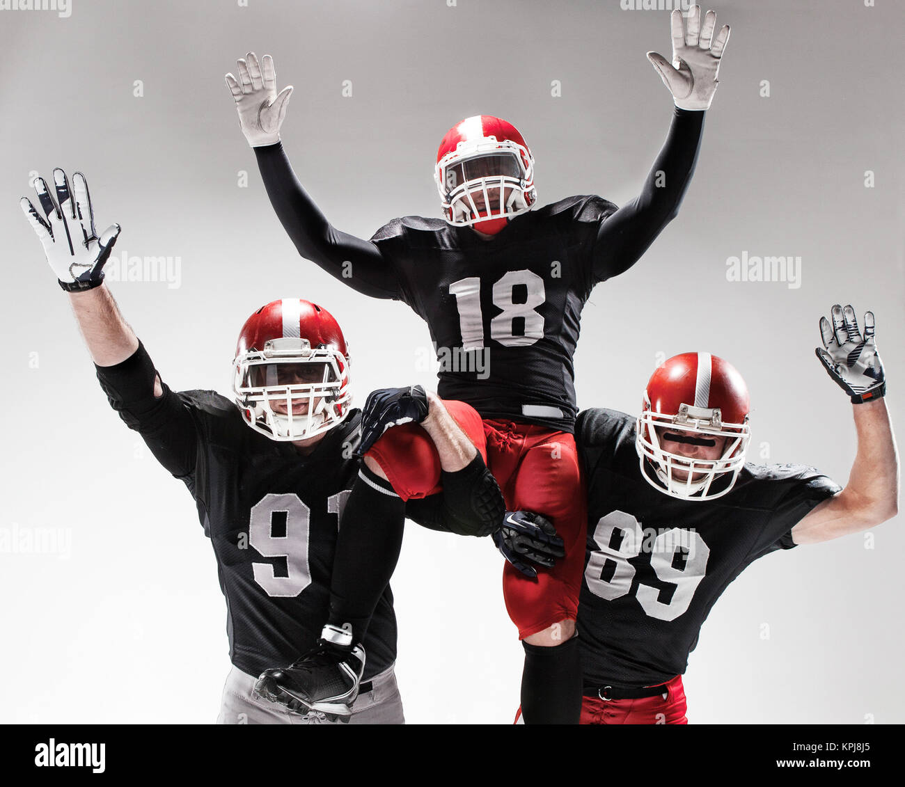 The three american football players posing on white background Stock ...