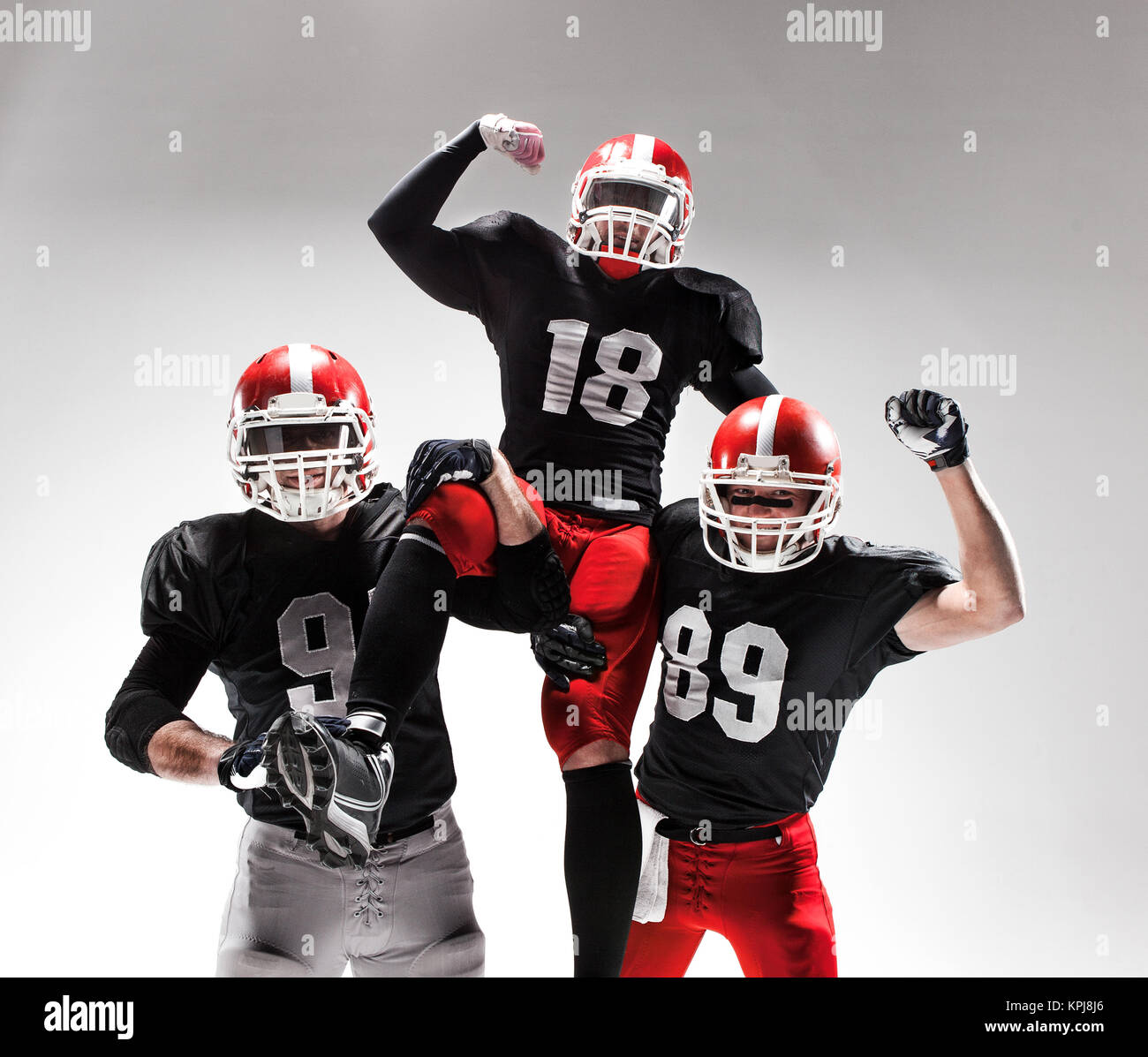 The three american football players posing on white background Stock ...