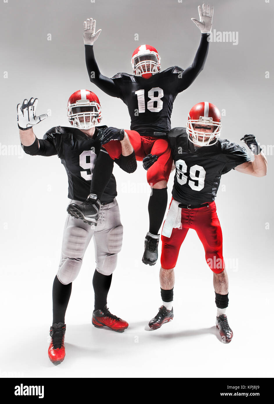 The three american football players posing on white background Stock ...