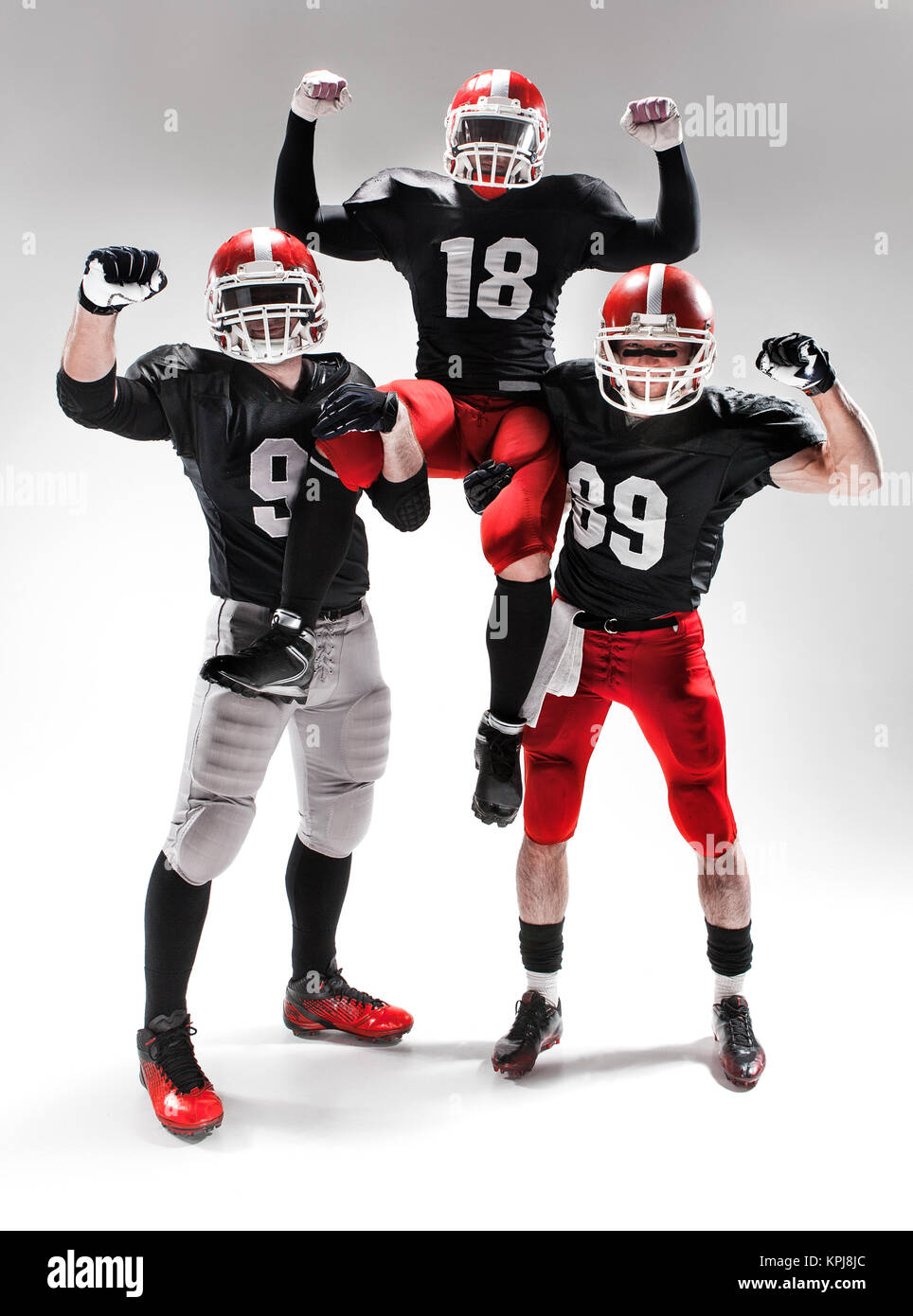 The three american football players posing on white background Stock ...