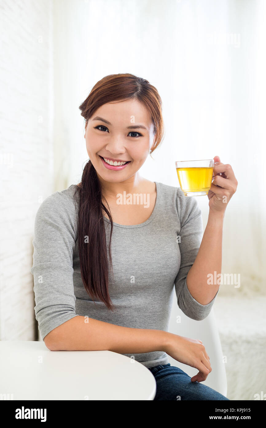 Young Woman hold a glass of tea Stock Photo - Alamy