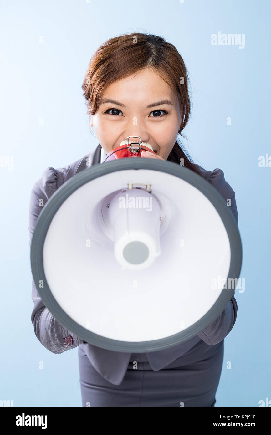 Businesswoman shouting with loudspeaker Stock Photo - Alamy