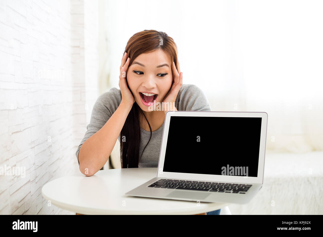Excited woman showing blank screen of laptop computer Stock Photo - Alamy