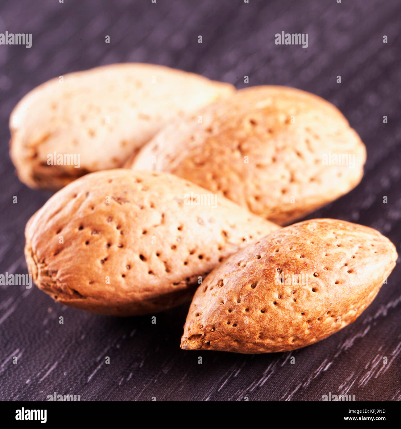 Almonds over wood Stock Photo - Alamy