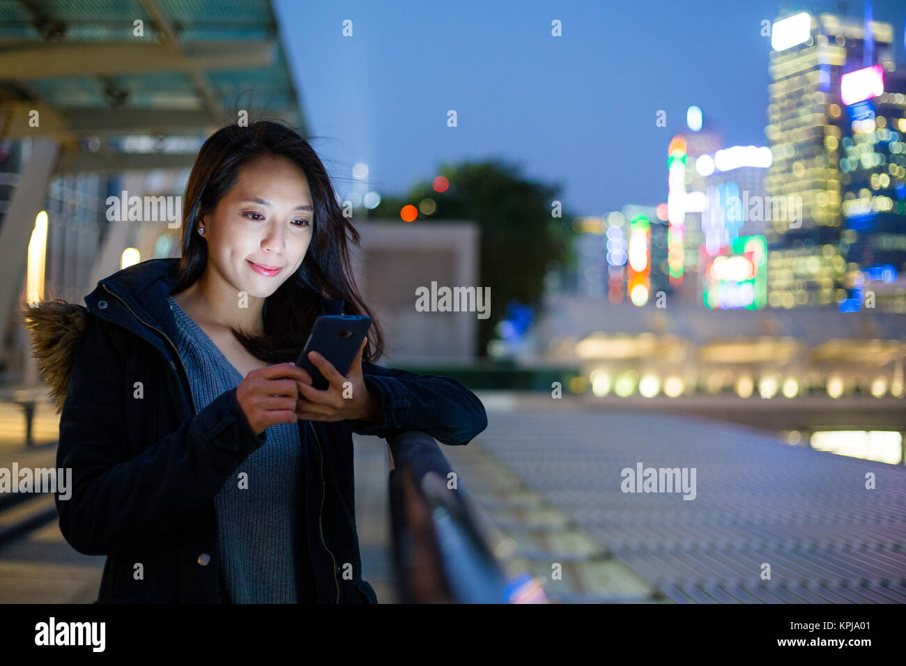 Woman use of mobile phone at night Stock Photo - Alamy