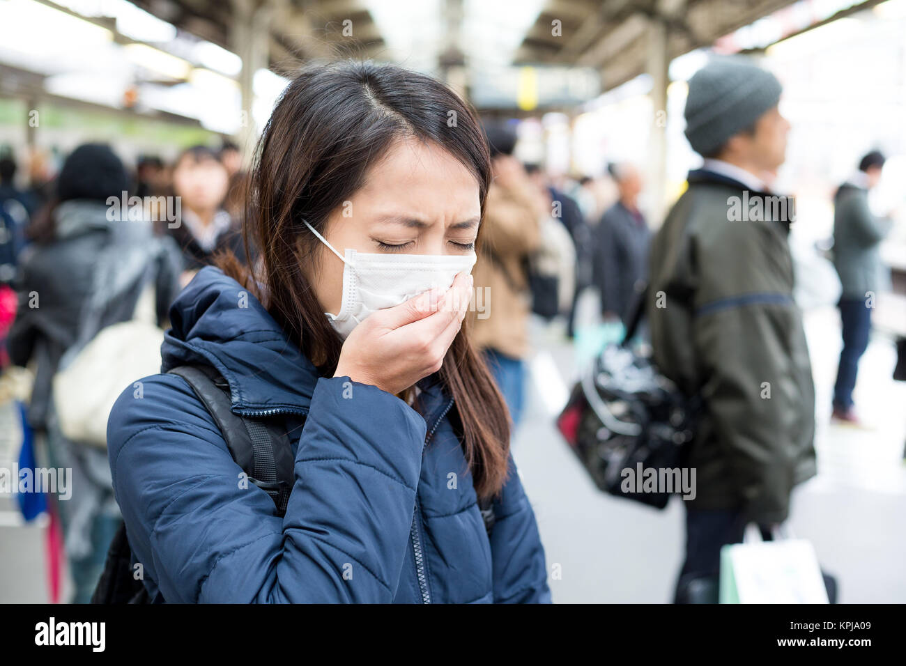 Woman feeling uncomfortable in train station Stock Photo - Alamy
