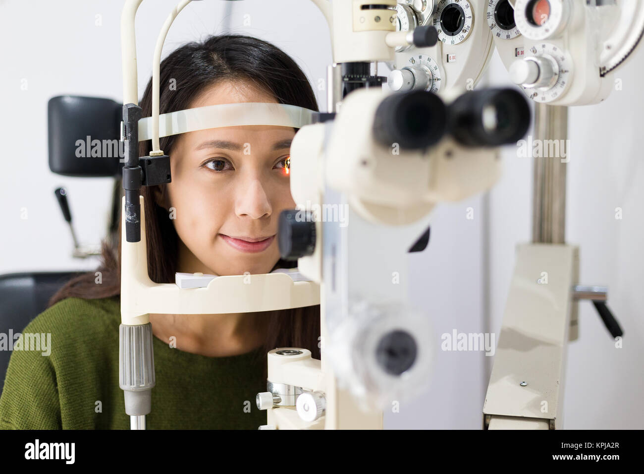 Woman checking vision with equipment Stock Photo - Alamy