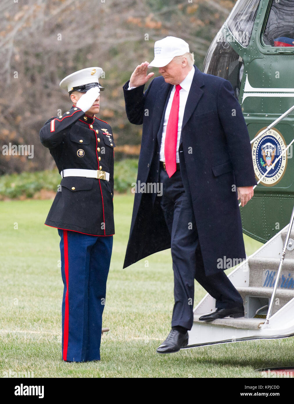 United States President Donald J. Trump salutes the Marine Guard as he ...