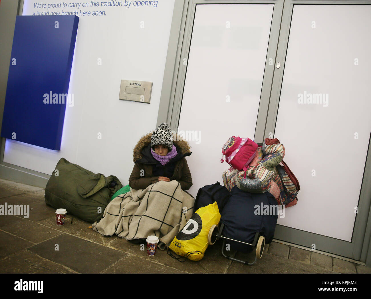 Manchester, UK. 16th December, 2017. A homeless women sat with her ...