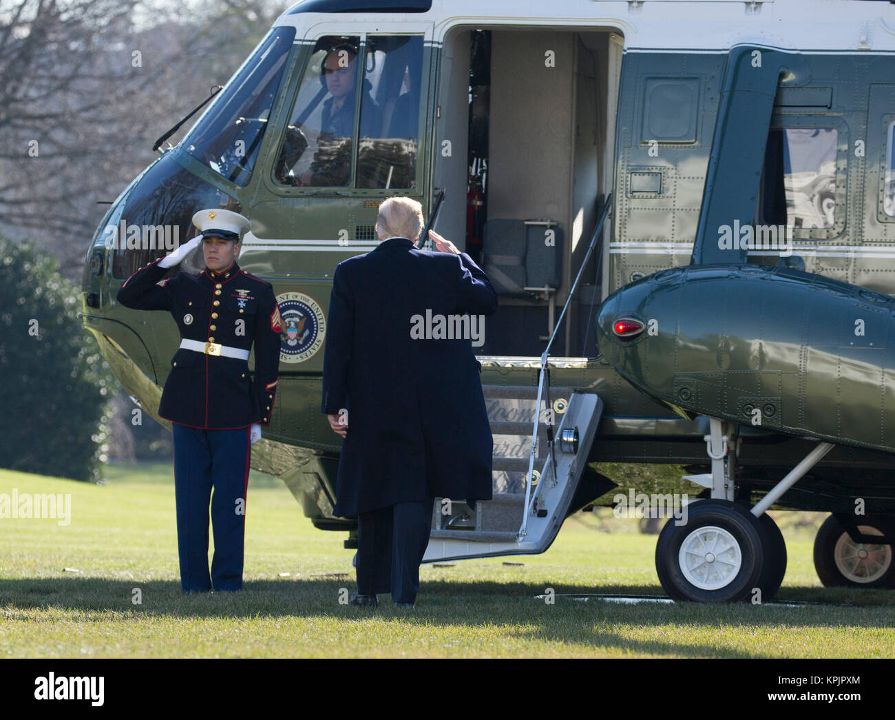 United States President Donald J. Trump salutes the Marine Guard as he ...
