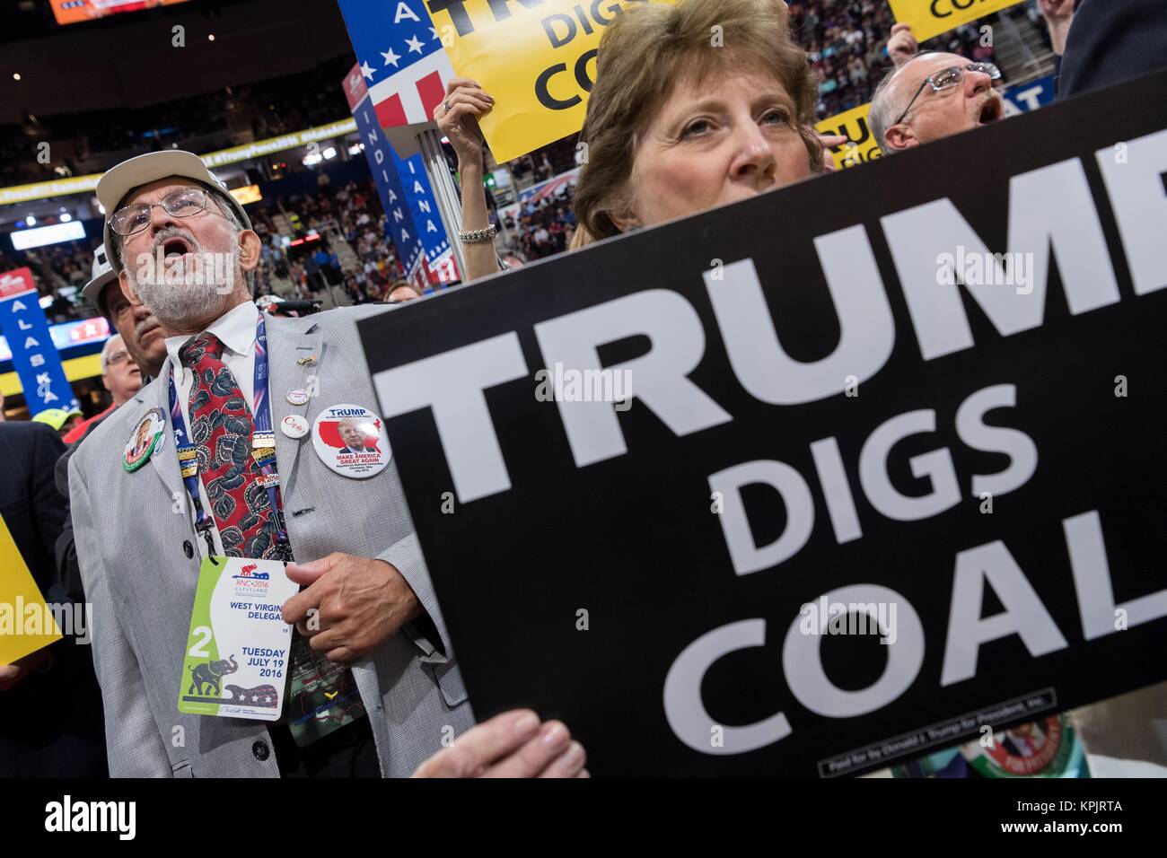Coal supporters hold up signs that say Trump Digs Coal during an ...