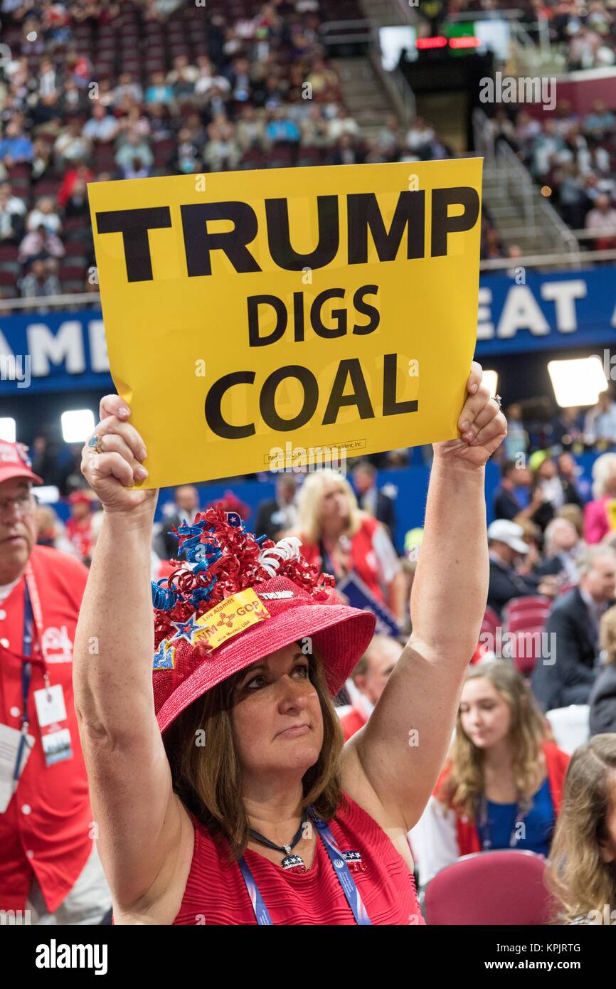 Coal supporters hold up signs that say Trump Digs Coal during an ...