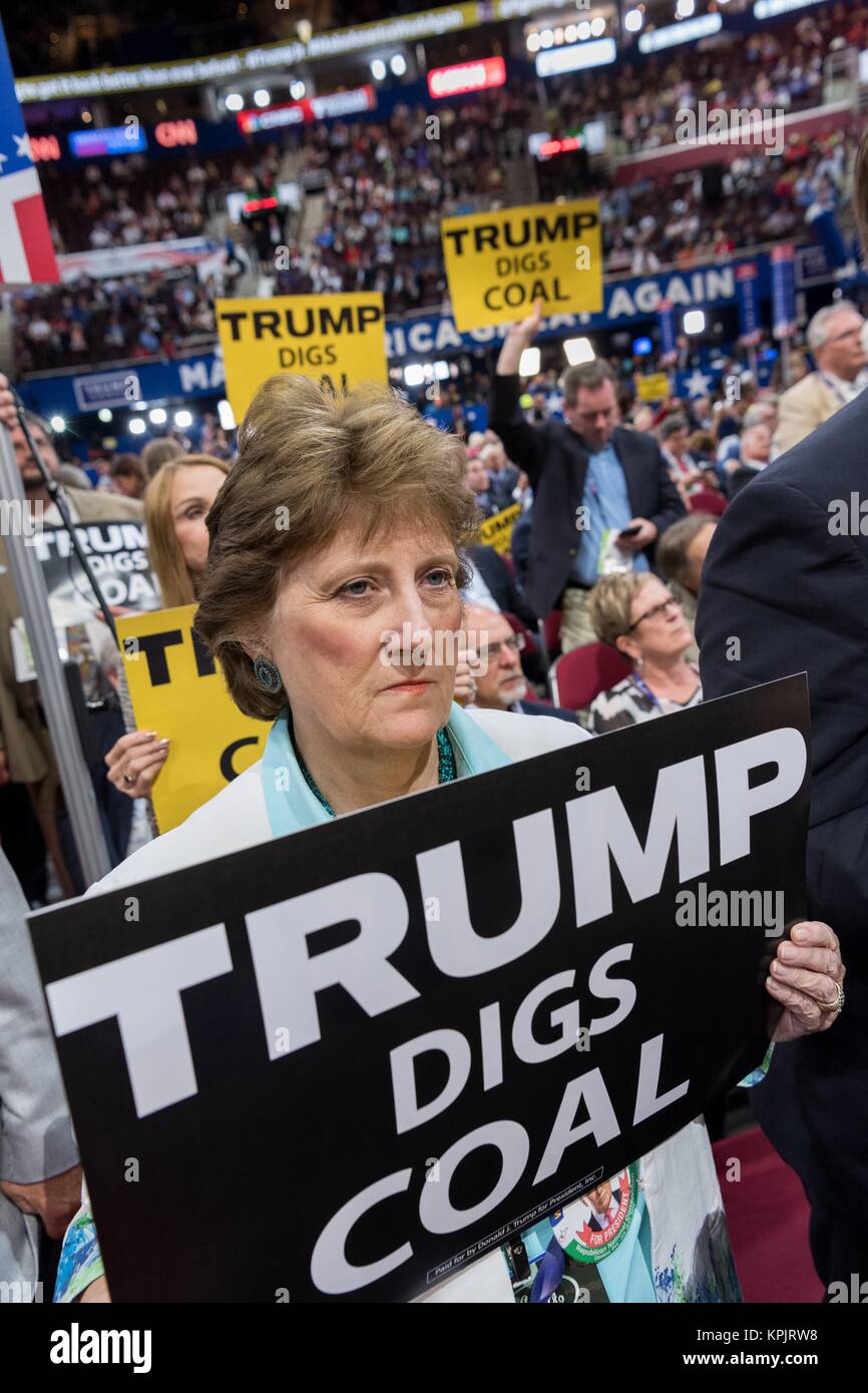 Coal supporters hold up signs that say Trump Digs Coal during an ...