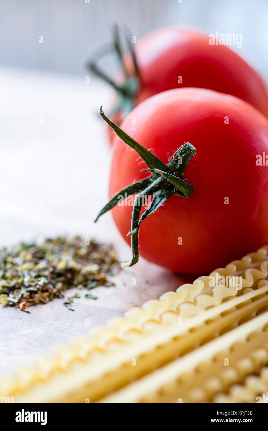 Dry spaghetti, fresh tomatoes and Italian herbs, macro. Ingredients of ...
