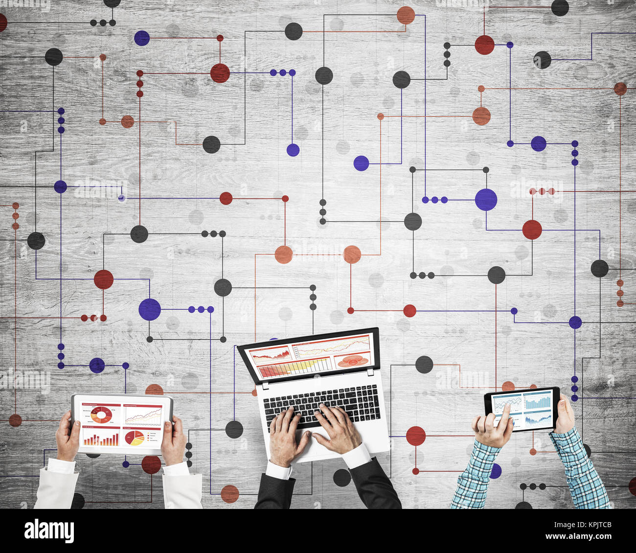 Group of three people with devices in hands working together as symbol ...