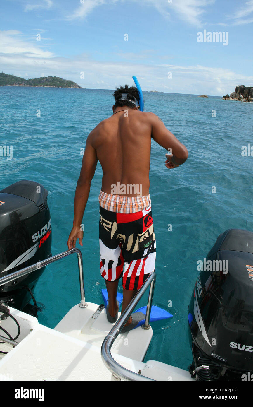 Seychellian man preparing to snorkel, Felicite Island, Seychelles Stock ...