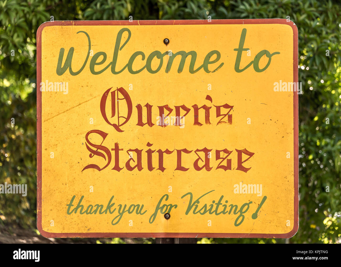 Yellow welcome sign greeting visitors at the top of Queen's Staircase ...