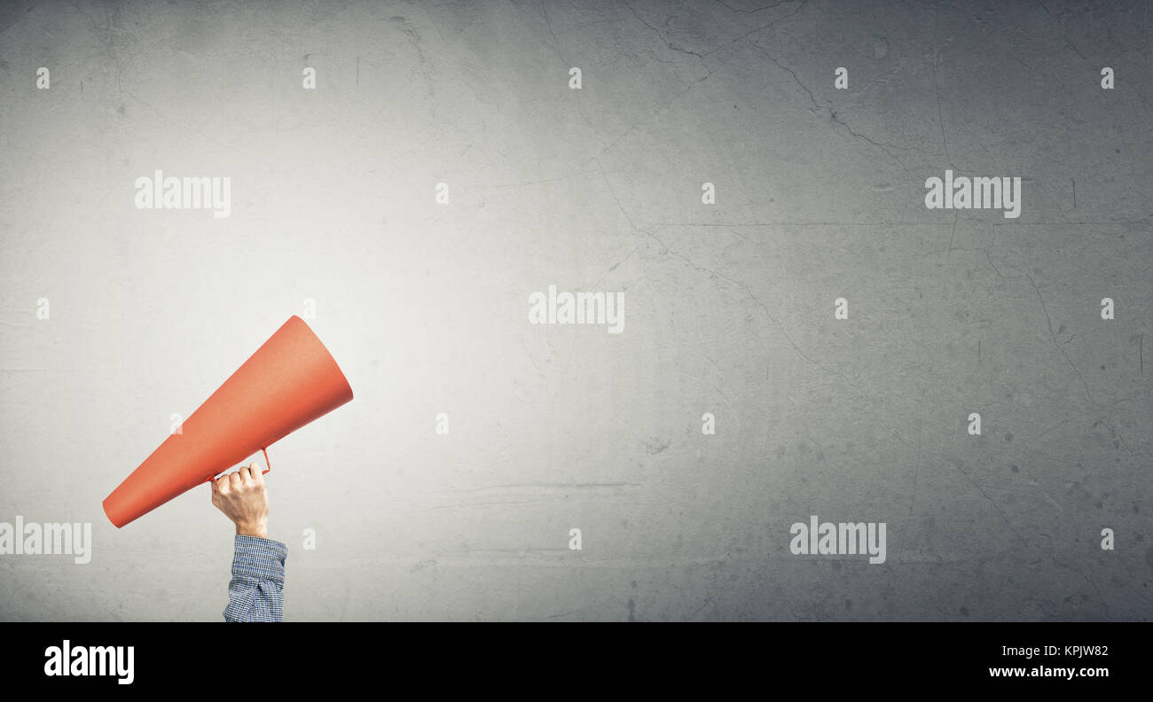 Close of man making announcement in paper trumpet Stock Photo - Alamy