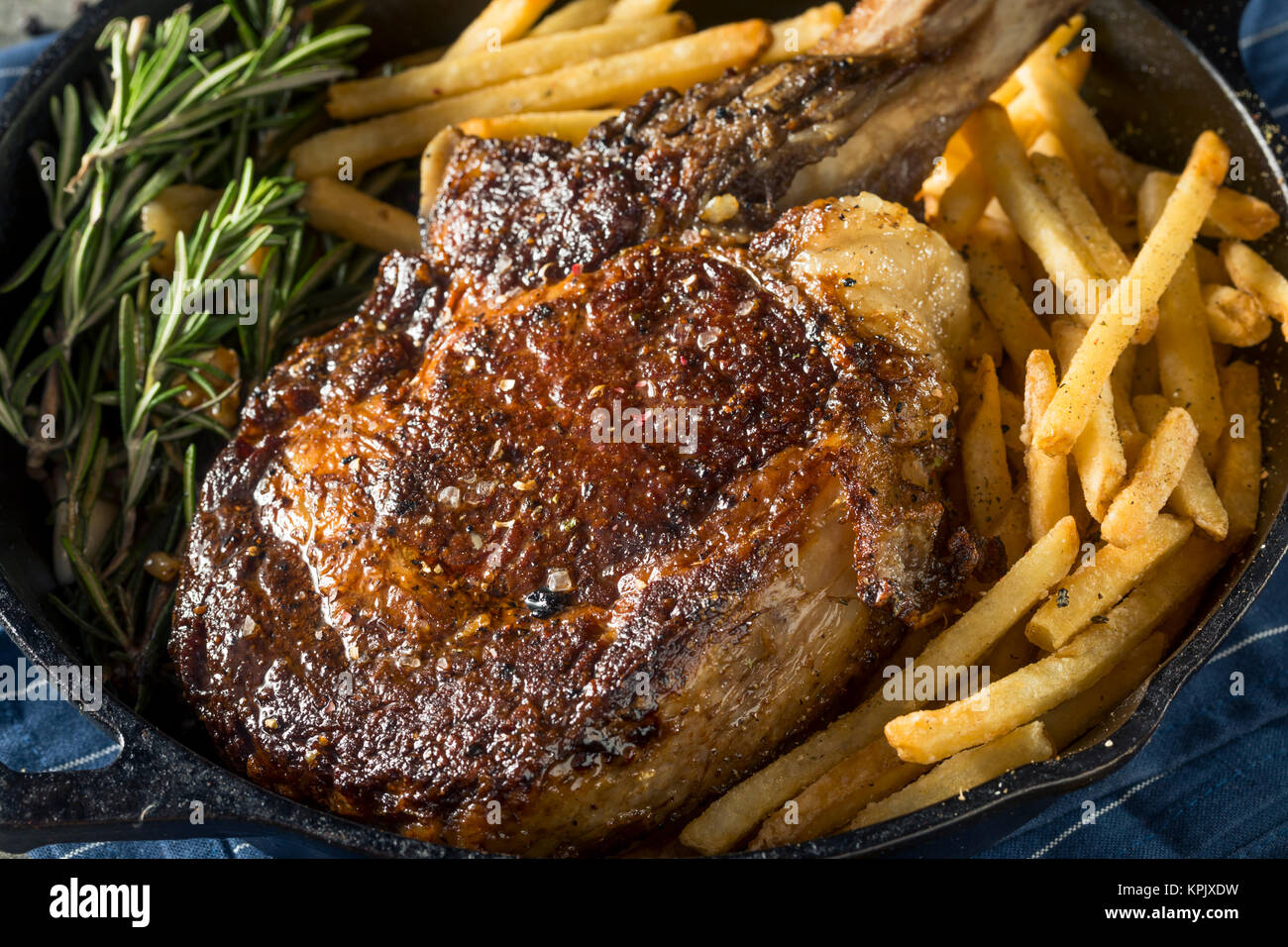 Cooked Grass Fed Tomahawk Steaks with Fries and Rosemary Stock Photo ...