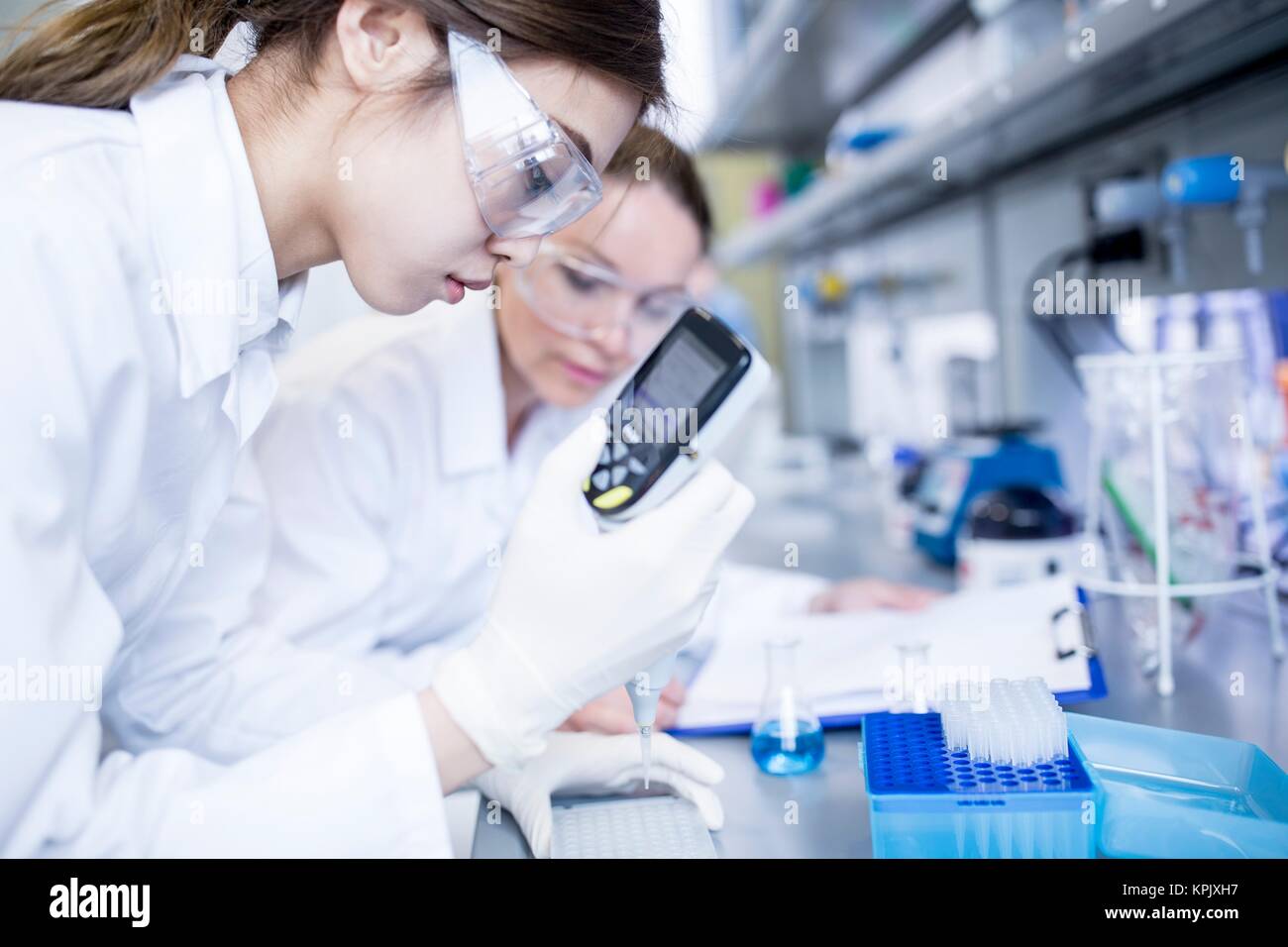 Laboratory assistants using pipette with digital display Stock Photo ...