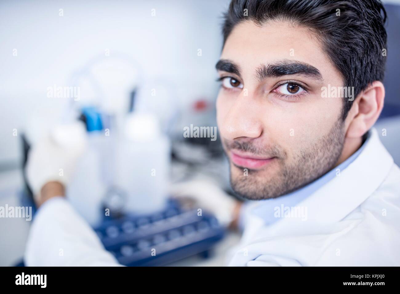 Male laboratory assistant using equipment Stock Photo - Alamy