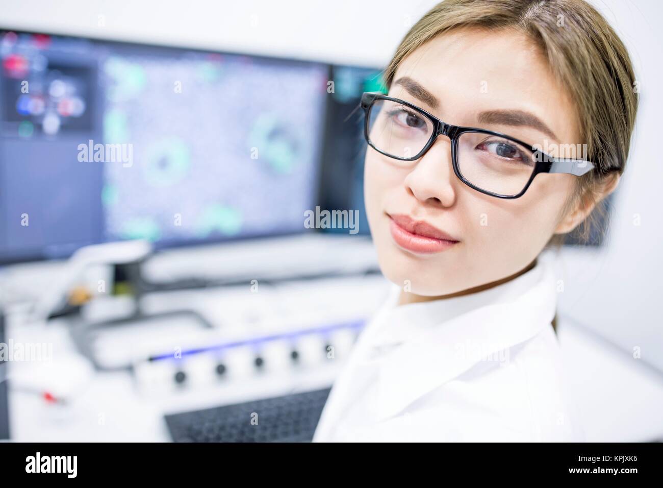 Female scientist wearing glasses, looking at camera Stock Photo - Alamy