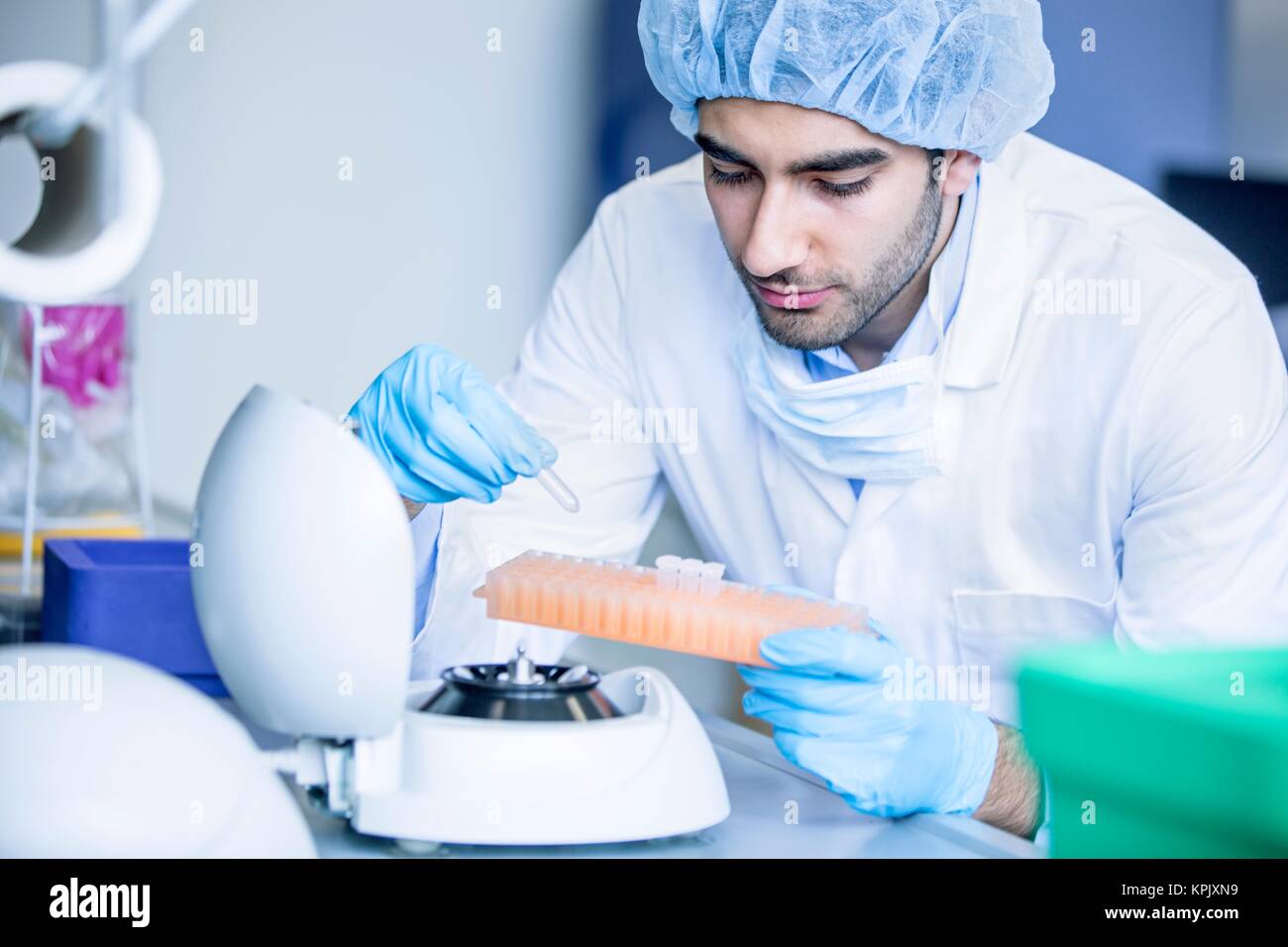 Male scientist wearing protective clothing working in laboratory Stock ...