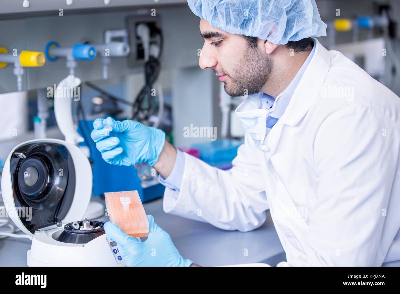 Male scientist wearing protective clothing working in laboratory Stock ...