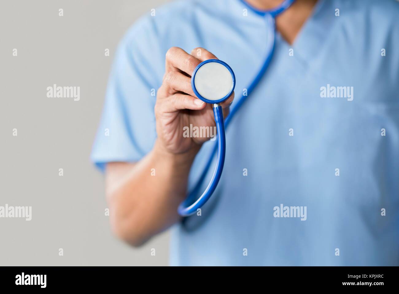Male doctor in blue uniform with stethoscope Stock Photo - Alamy