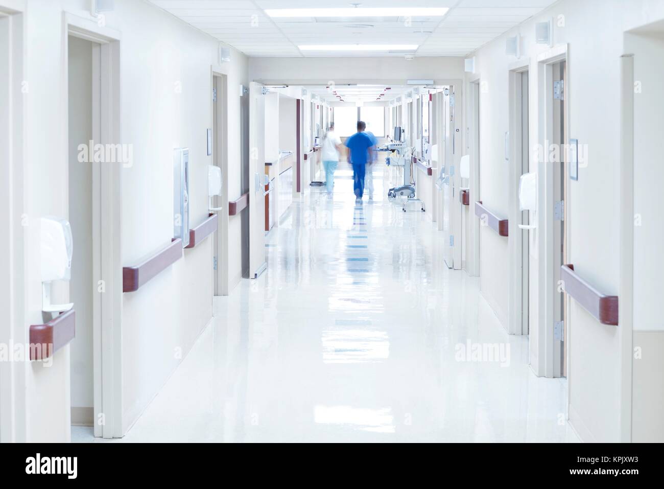 Doctor walking down hospital corridor Stock Photo - Alamy