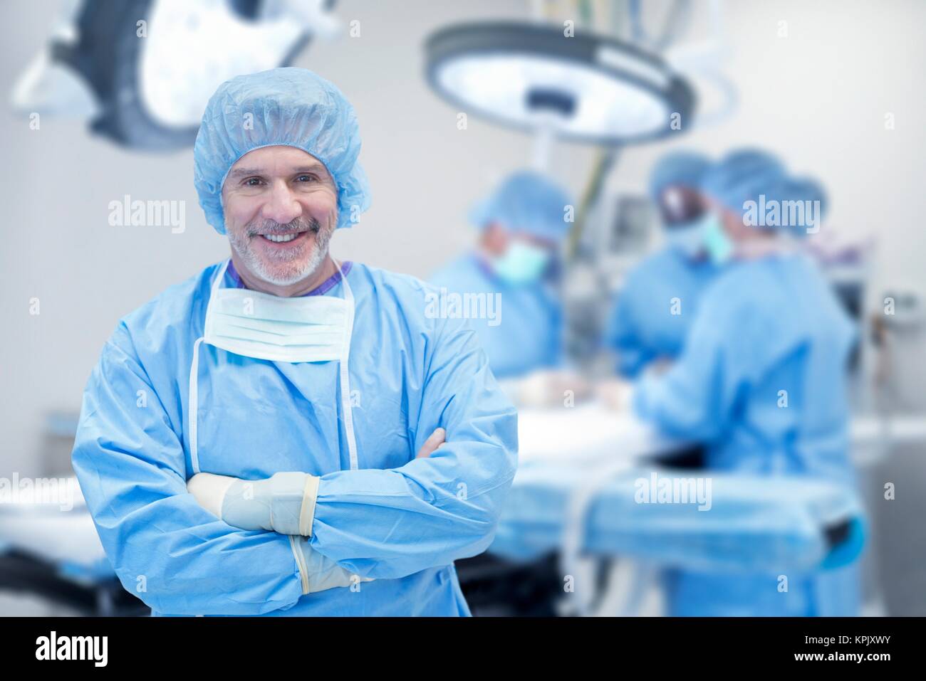 Male surgeon smiling towards camera, portrait Stock Photo - Alamy