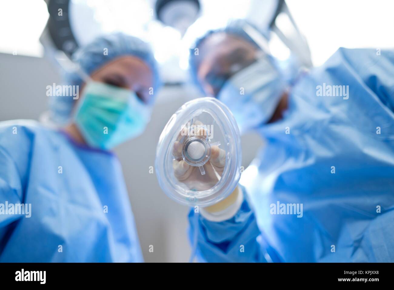 Nurse holding gas mask, female doctor in the background Stock Photo - Alamy