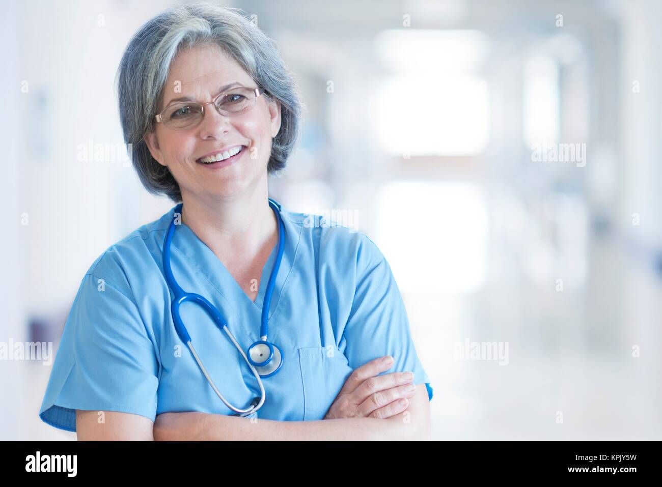 Mature female doctor smiling, portrait Stock Photo - Alamy