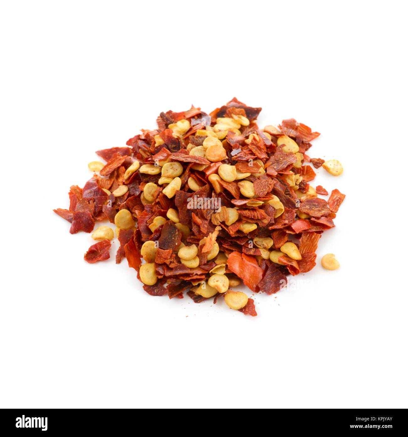 Chilli flakes against a white background Stock Photo - Alamy