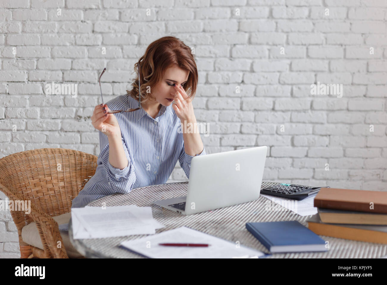 Tired businesswoman holding eyeglasses and massaging eyelids Stock ...