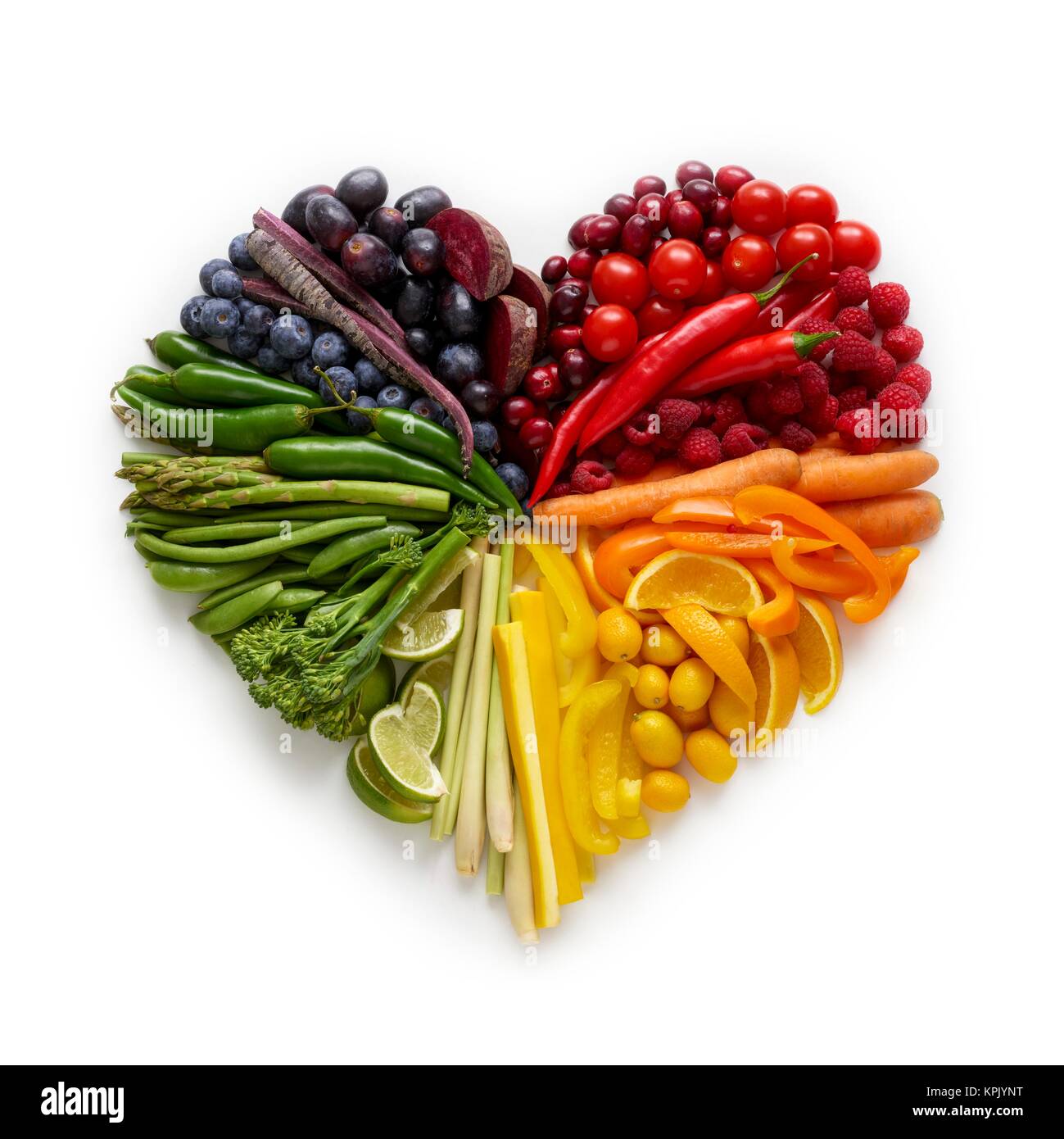 Fresh rainbow colours produce in a heart shape against a white ...