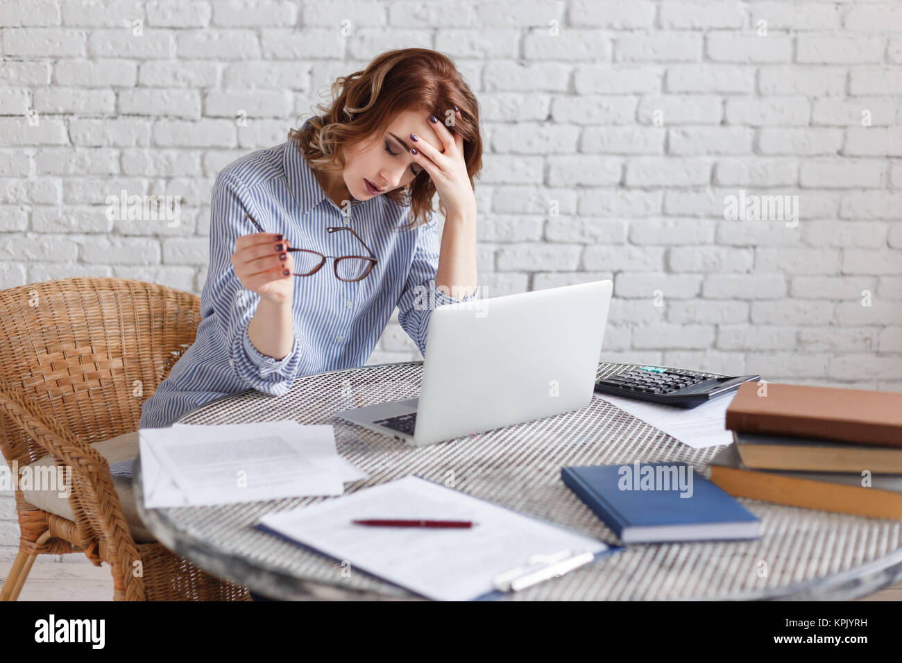 Tired young woman at the office Stock Photo - Alamy