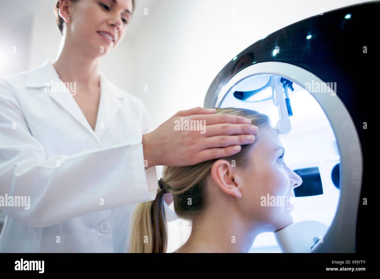 Young woman undergoing examination in skin clinic. This scan allows the ...