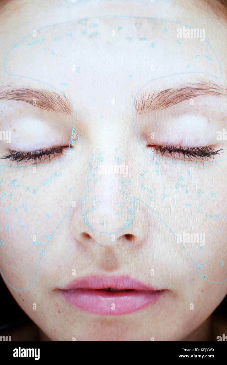 Image of young woman's face undergoing examination in skin clinic. This ...