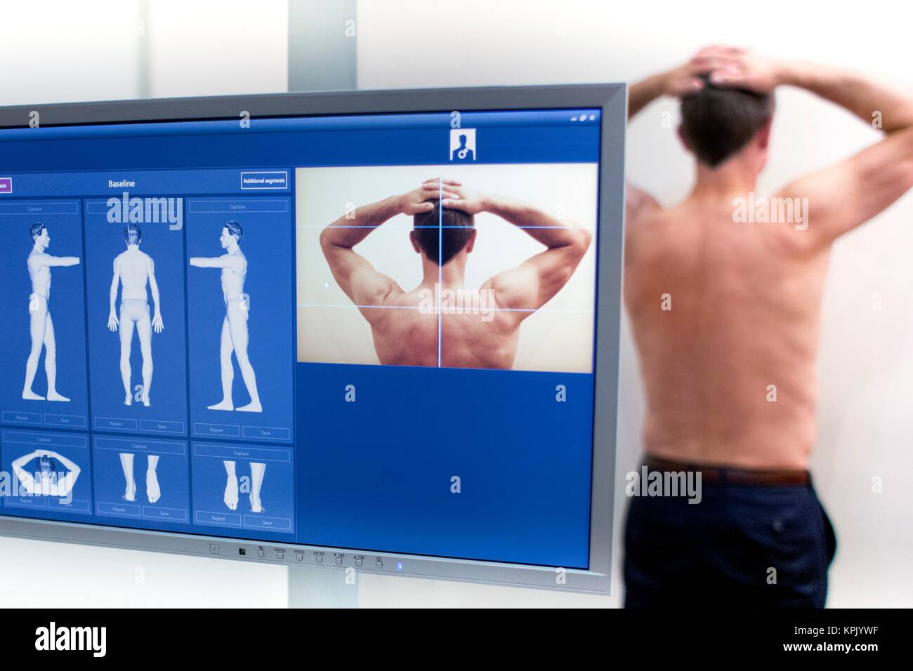 Male patient being examined in clinic, image of man on monitor in ...