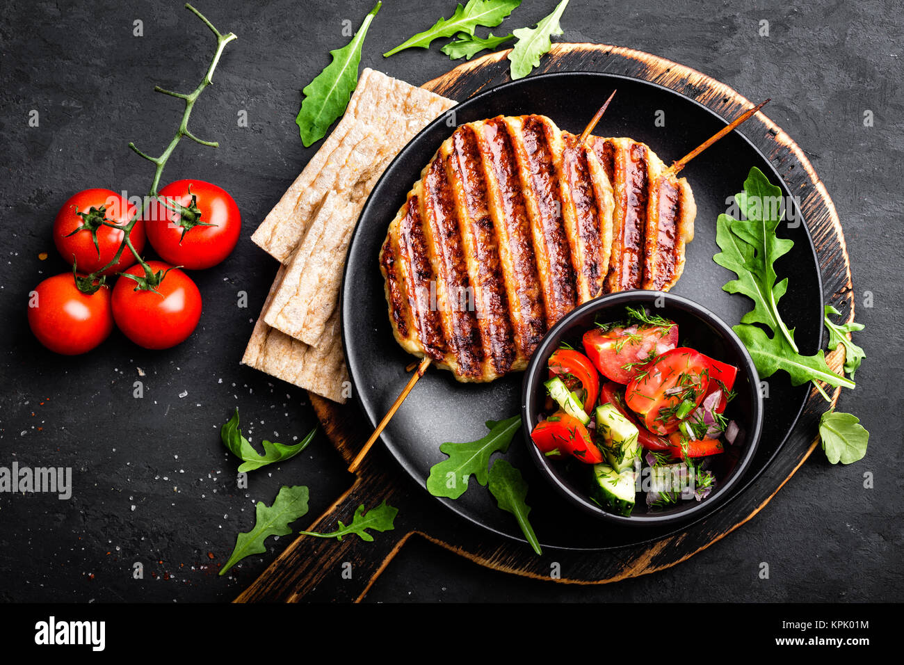 Juicy grilled chicken meat lula kebab on skewers with fresh vegetable ...