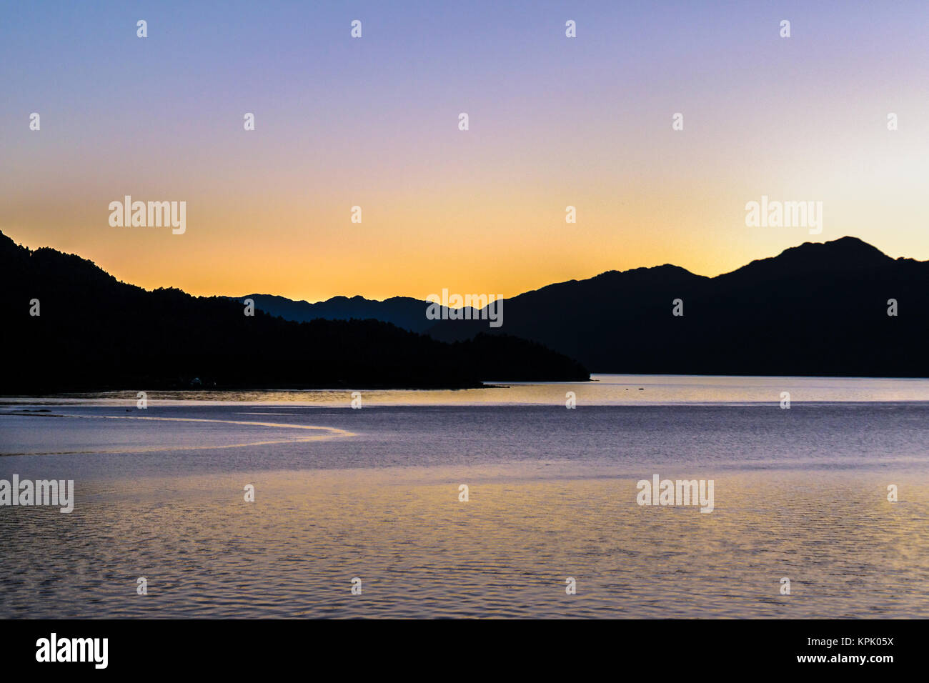 Sunset silhouette andes mountains and lake landscape scene at Patagonia ...