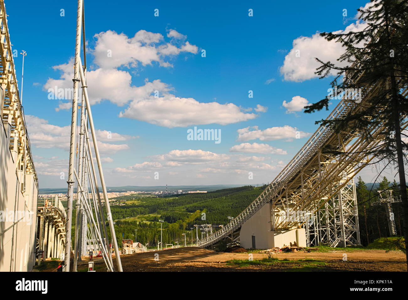 Metal structures of a large ski jumping-off against the sky and clouds ...