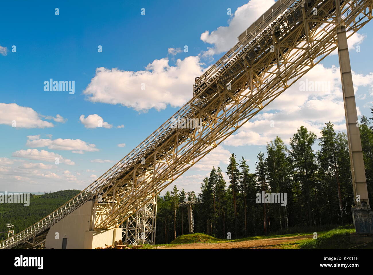 Metal structures of a large ski jumping-off against the sky and clouds ...